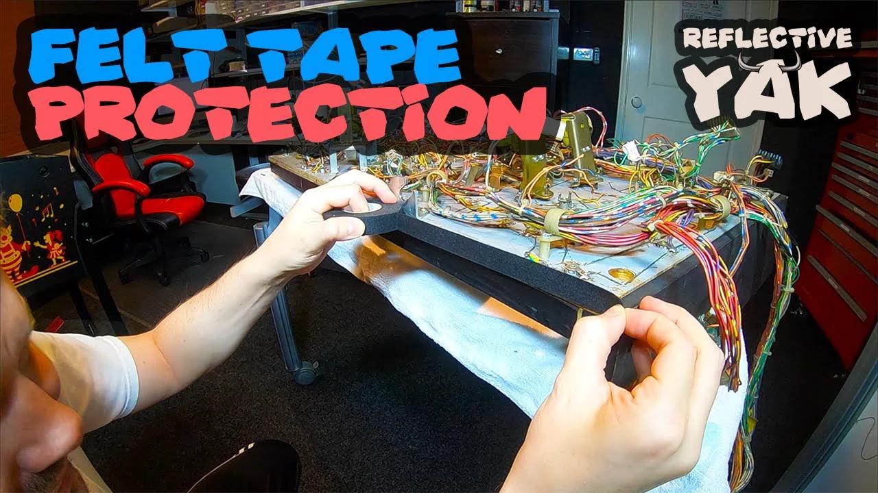 Applying felt tape to the edges of a pinball playfield