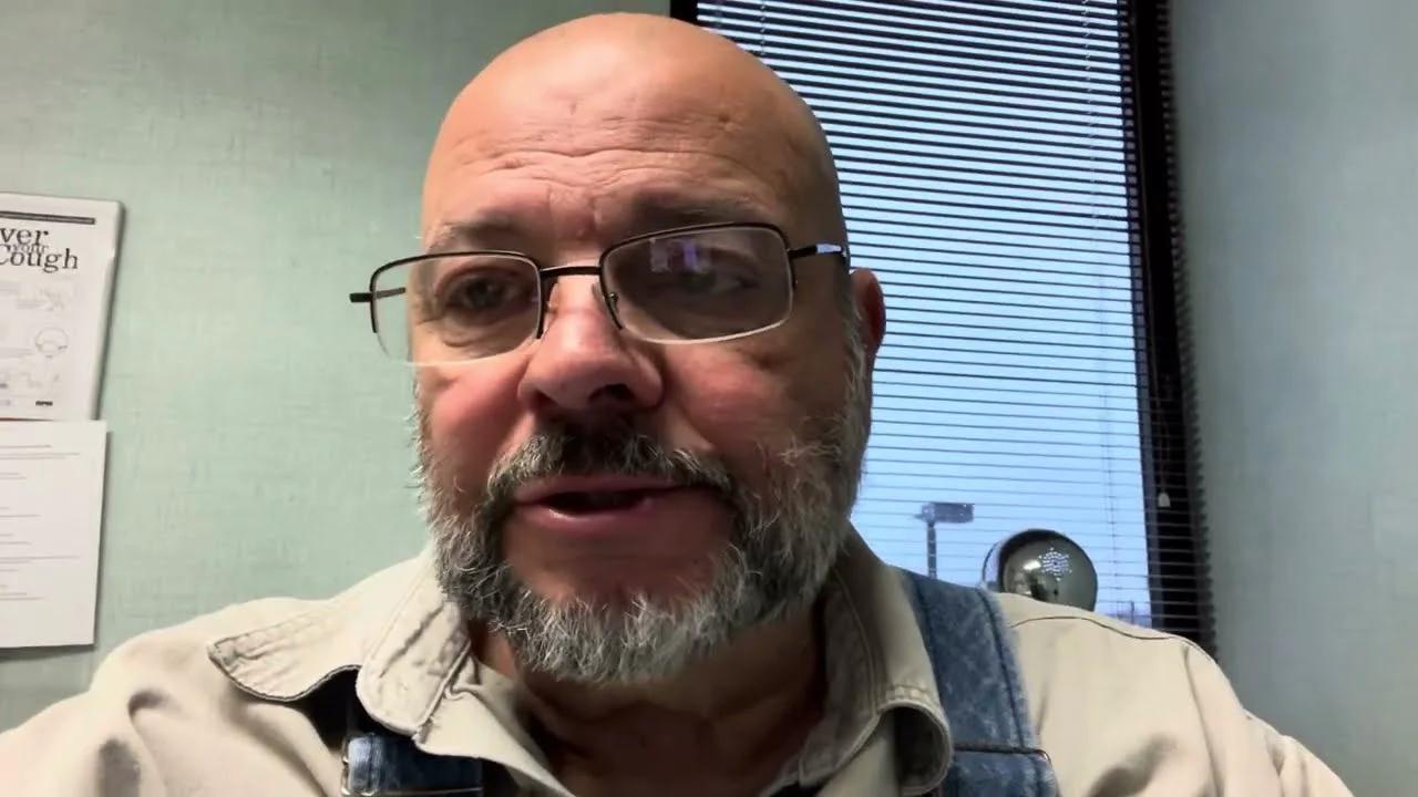 Man with large head at doctors office