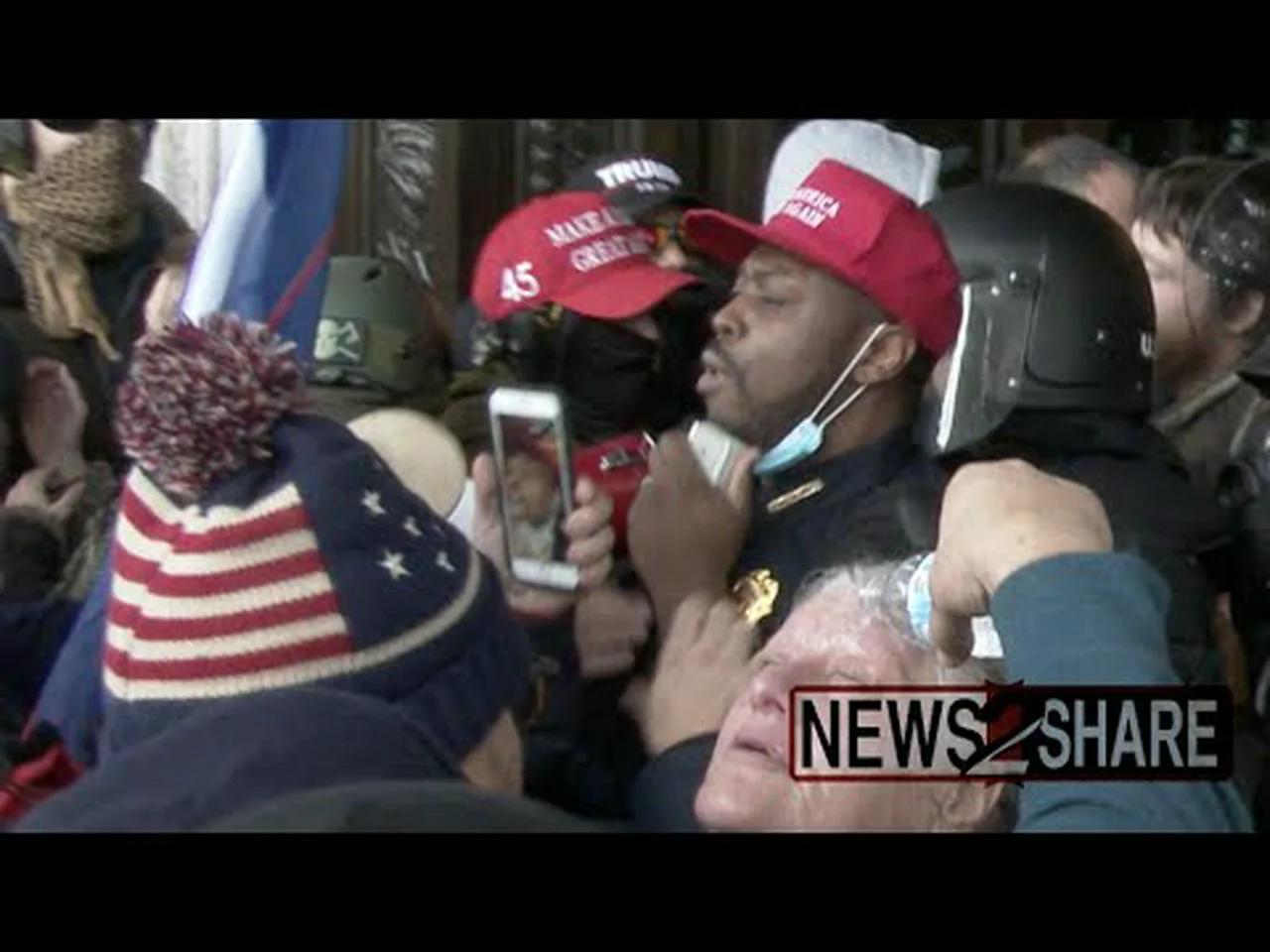 Archival January 6 footage - USCP Lt Tarik Johnson wears MAGA cap ...