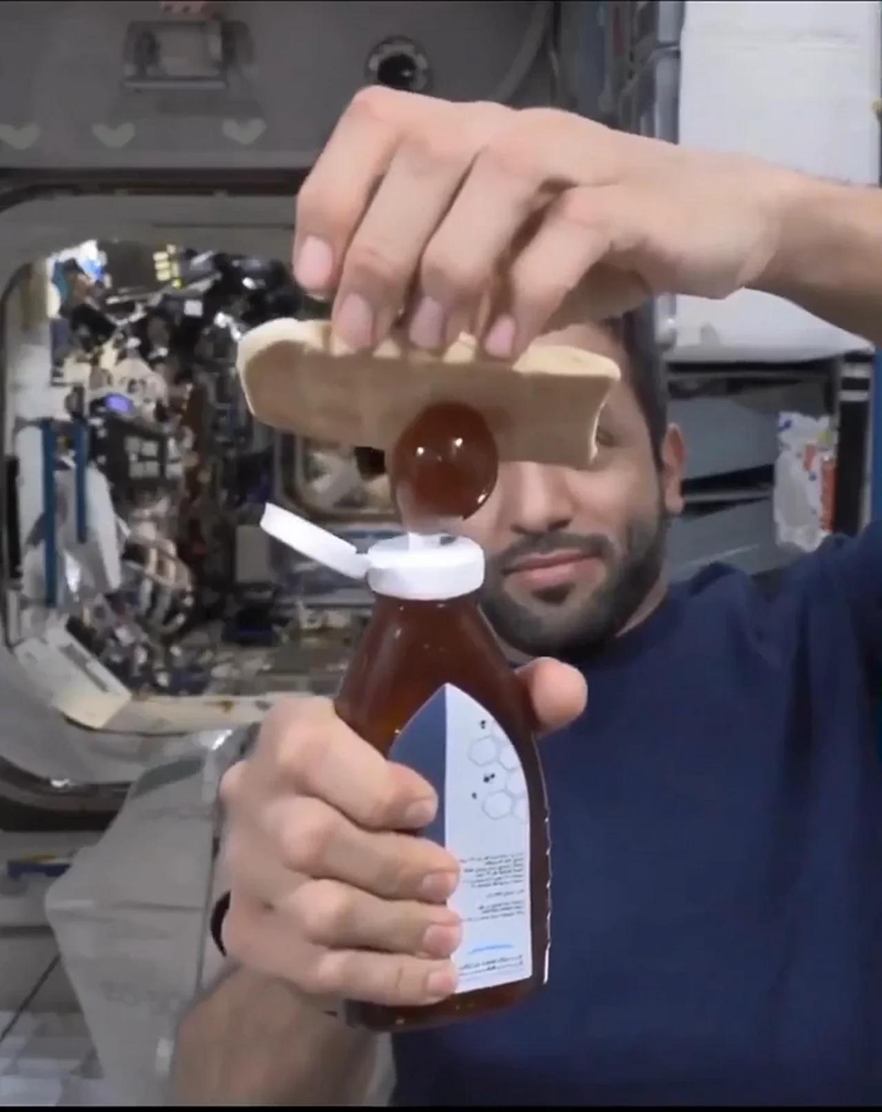 UAE astronaut eating bread and honey in space