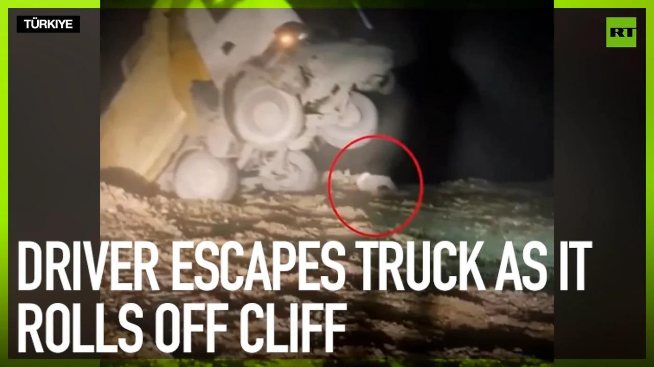 Driver escapes truck as it rolls off cliff